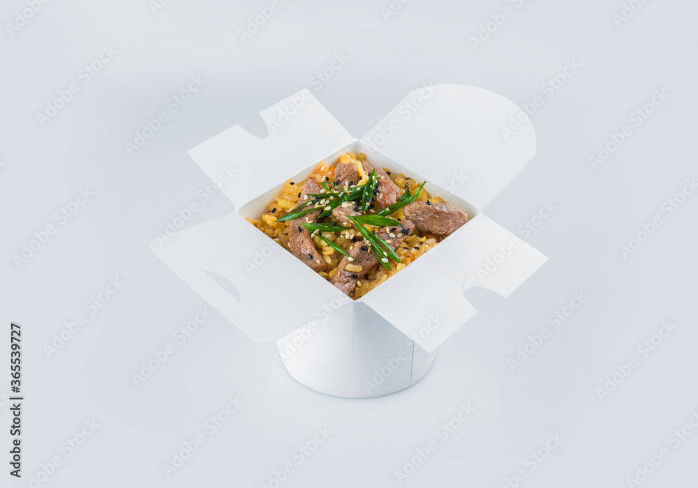 Isolated Chinese rice with beef fillet meat, vegetables, soy sauce and ...