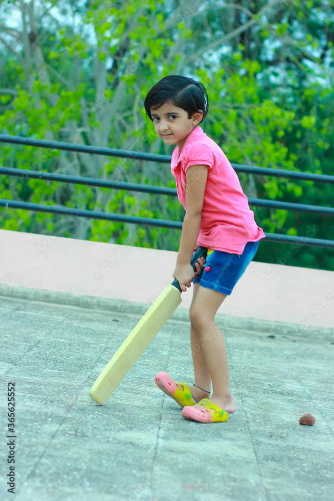 indian girl child playing cricket Stock Photo | Adobe Stock