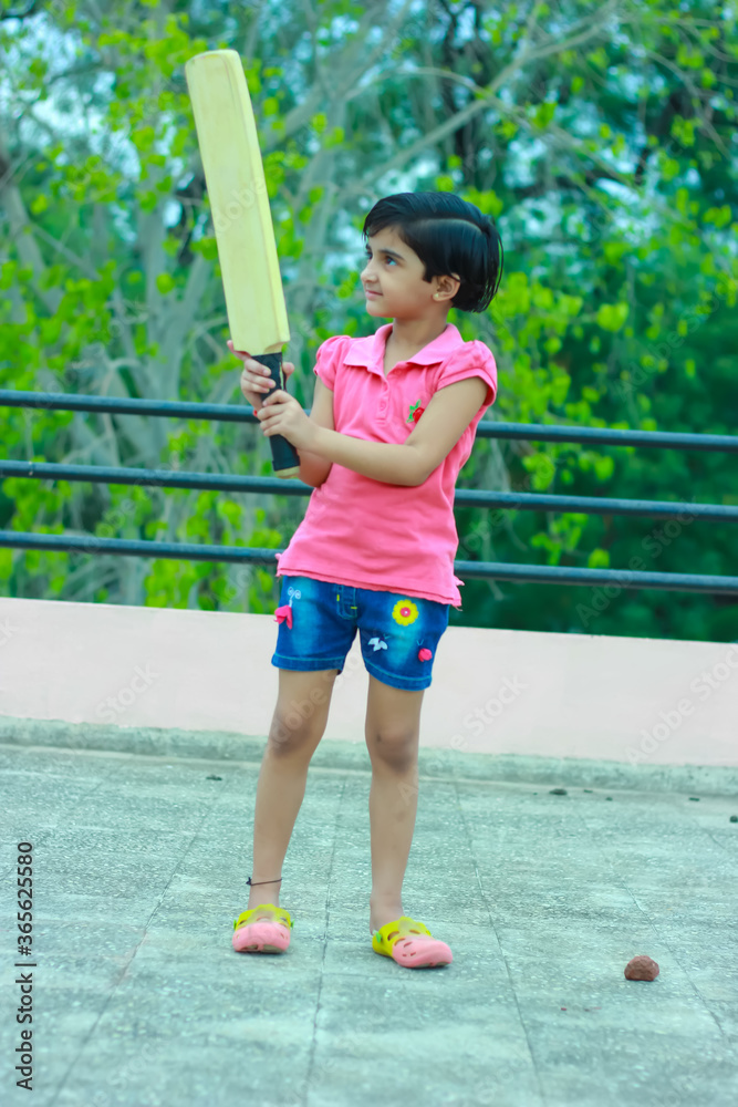 indian girl child playing cricket Stock Photo | Adobe Stock