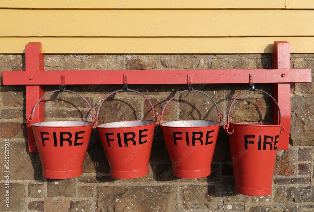 A row of four red fire buckets on the wall of the signal box at the now ...