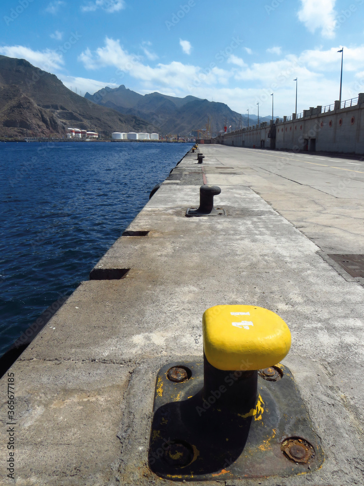 Perspective view of metal mooring bollards in port terminal dock ...