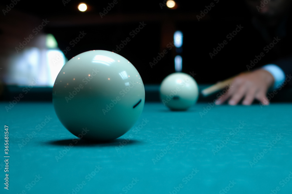 Foto de Playing billiards. Billiard balls and cue on a green pool table ...