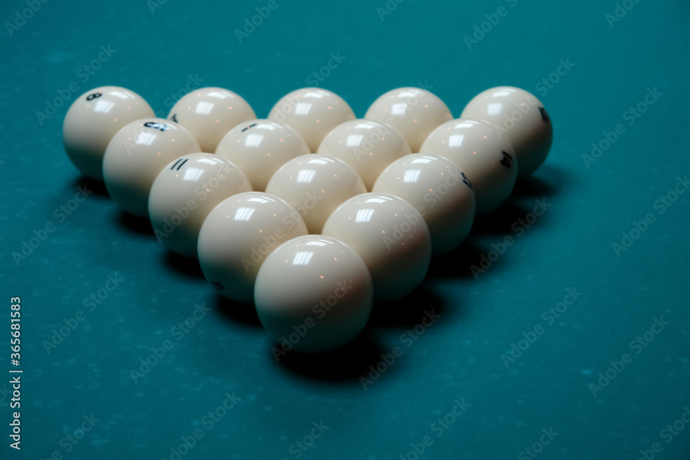 Pyramid, balls placed on a pool table tightly to each other in the form ...