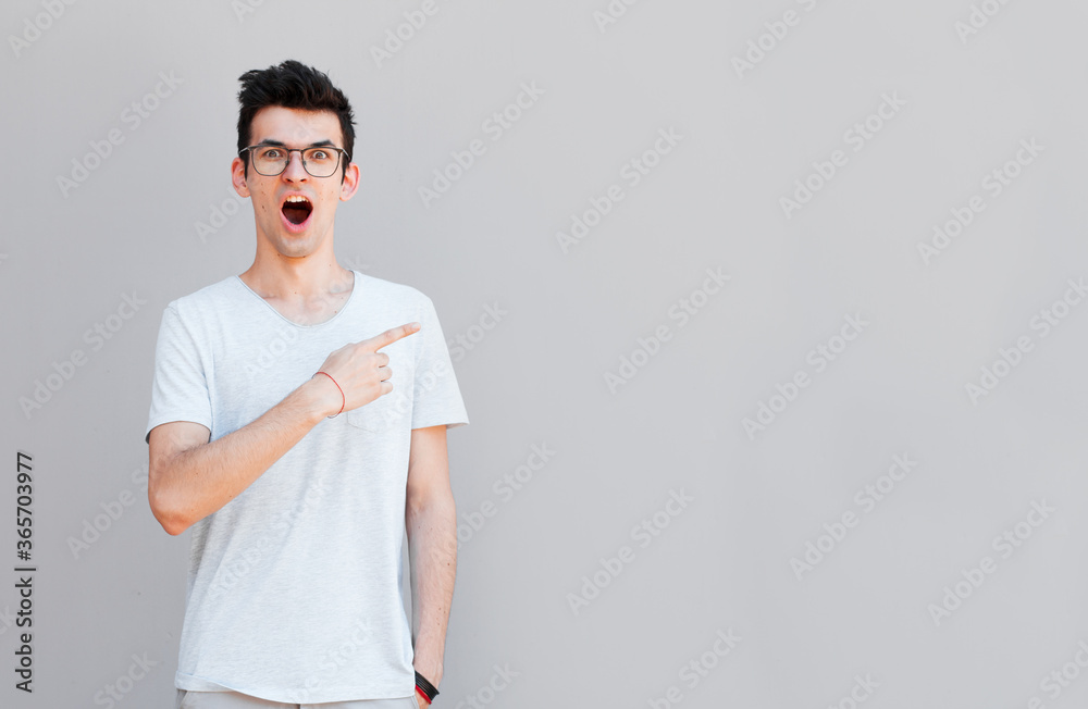 Man surprised shows on your product .Handsome guy with stylish ...
