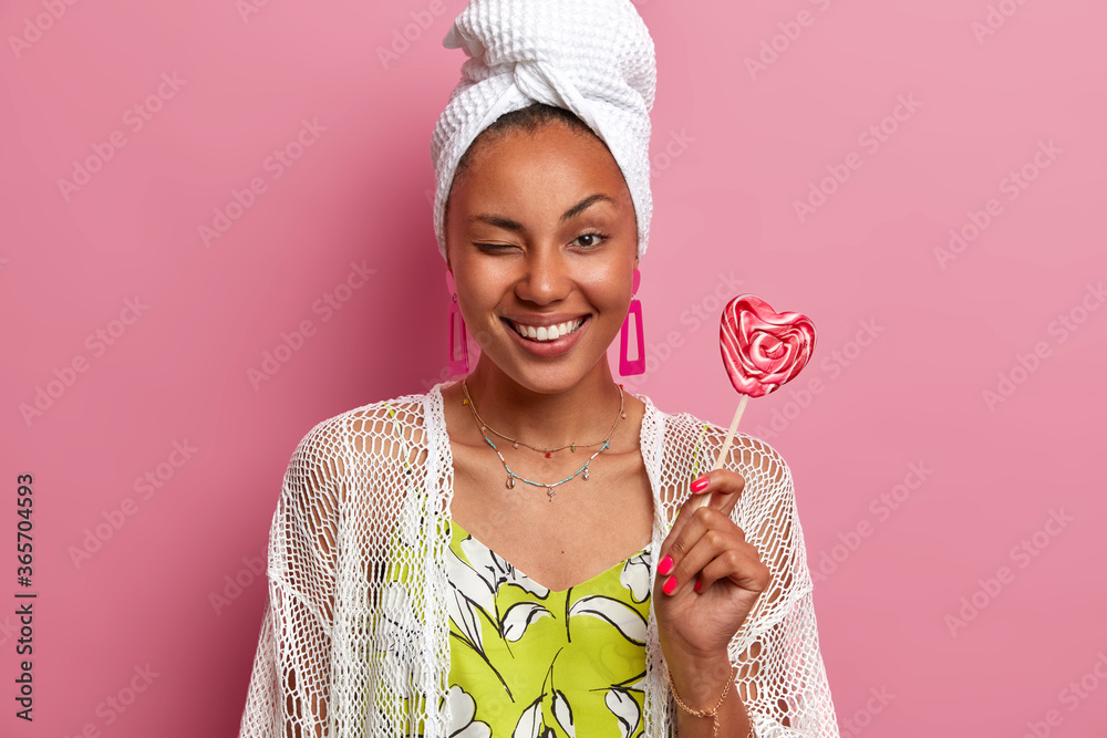 Happy cheerful woman feels refreshed after taking shower, wears wrapped ...
