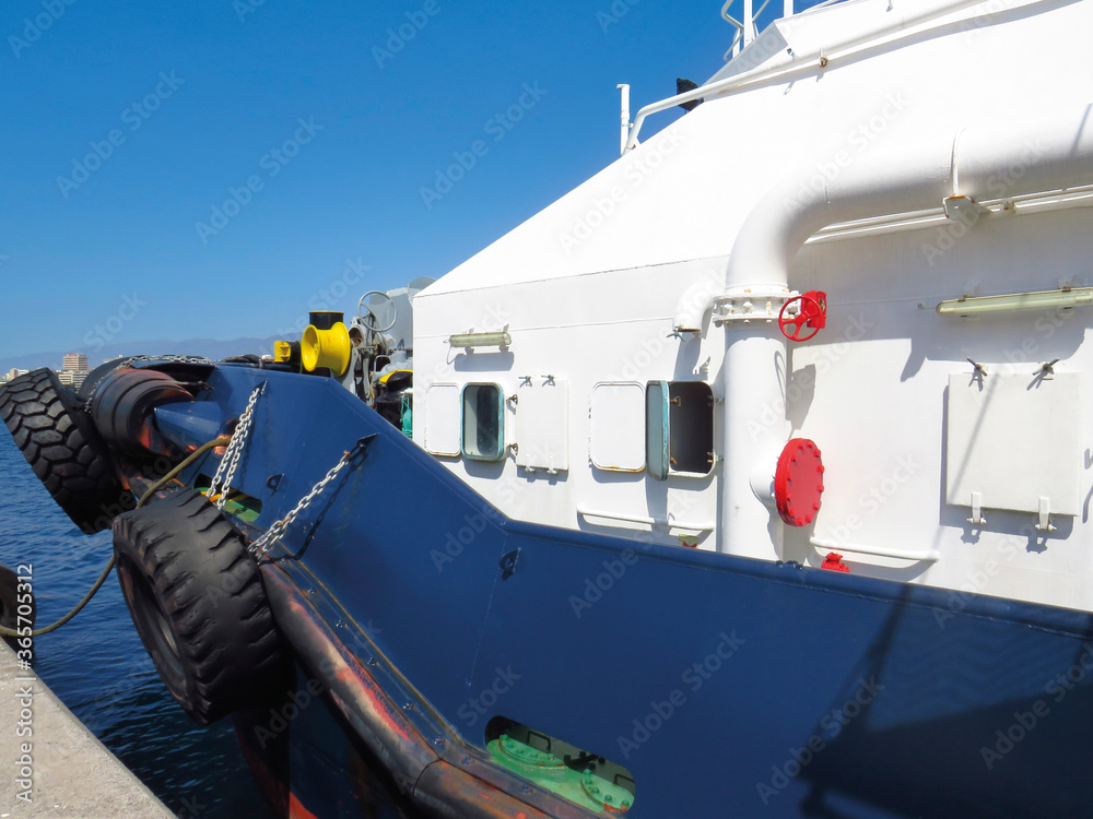 Side view of details of deck of tug boat docked at port dock ...