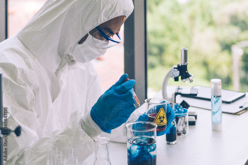 Lab Technician in Personal protective equipment PPE suit Vaccines ...