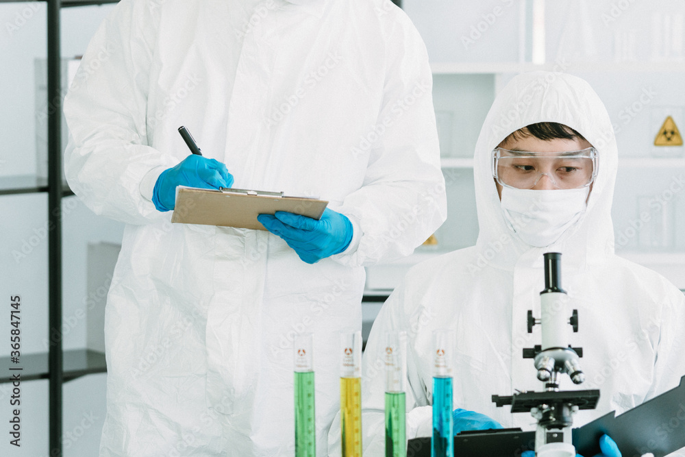 Lab Technician in Personal protective equipment PPE suit Vaccines ...