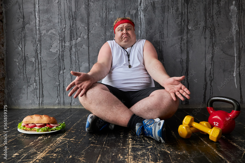 sad fat caucasian man is in a difficult position, man wants to eat a ...