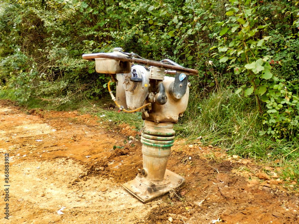 Hand operated whacker plate used to compact the earth prior to laying ...