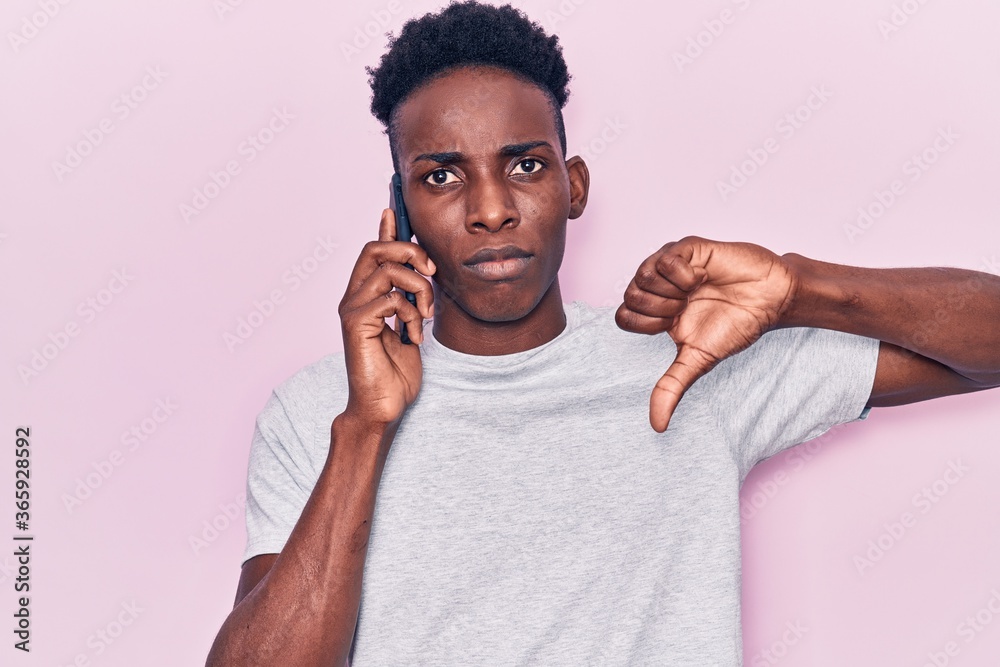 Young african american man having conversation talking on the ...