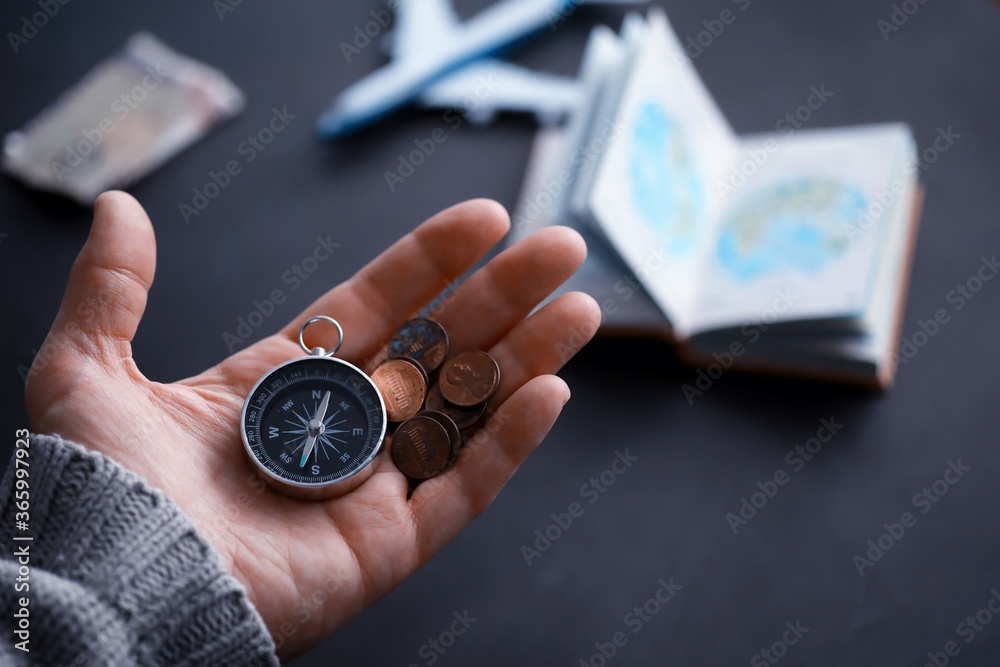 Travel concept. Magnetic compass in the hand. Retro navigator in hand a ...