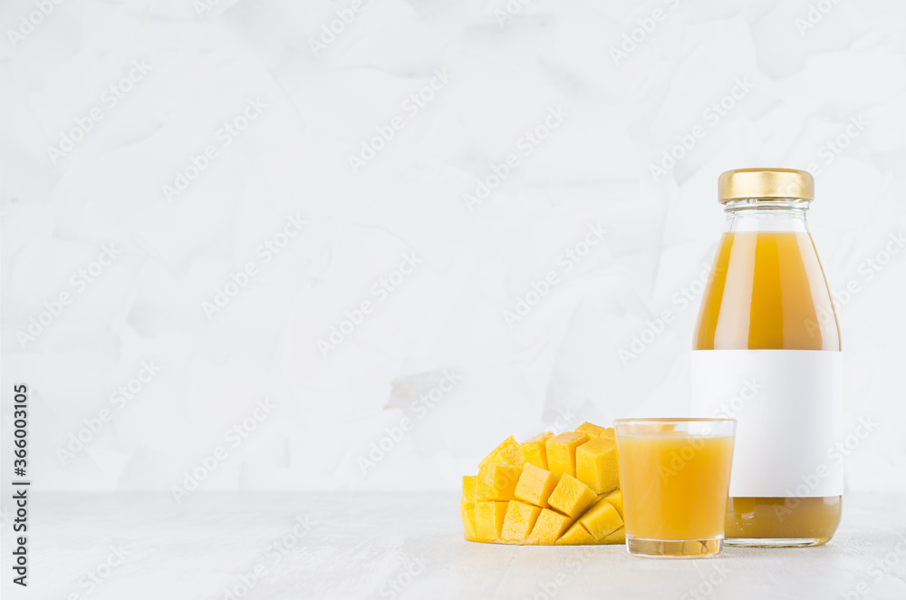 Bright orange pulpy mango juice in glass bottle mock up with blank ...