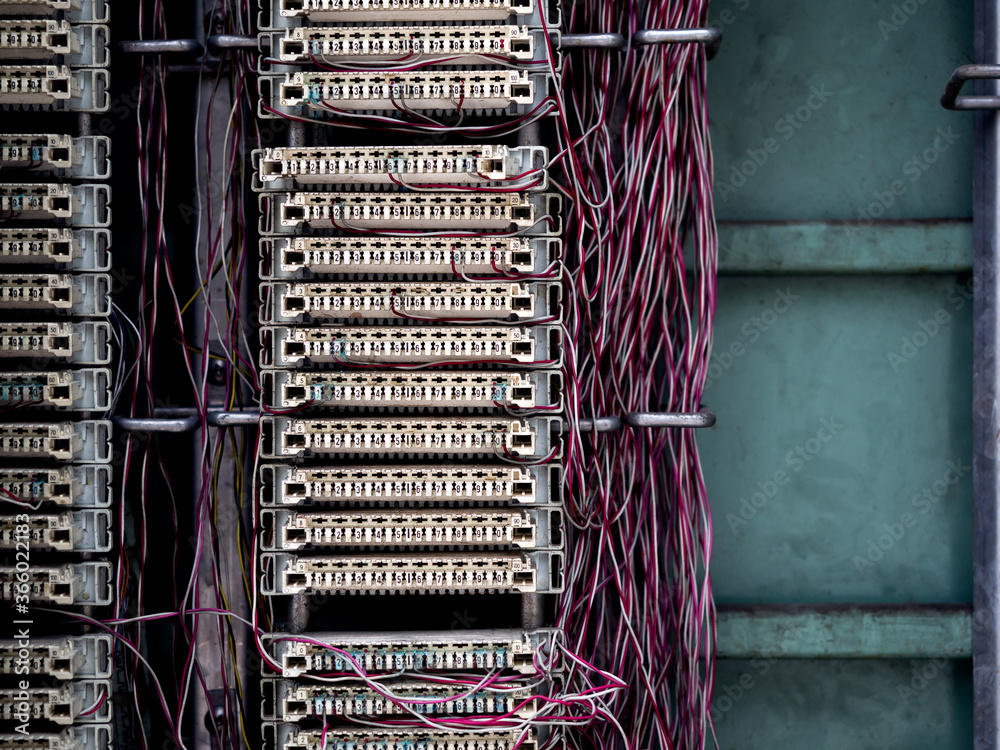 Old analog telephone switchboard system connection panel with wire ...
