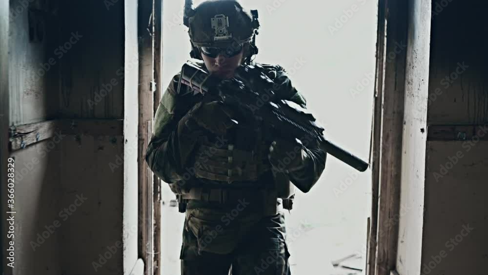 Soldier in full US MARSOC armed with assault rifle run through the ...