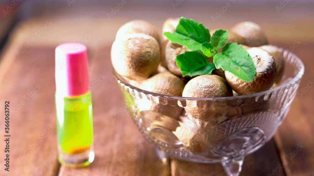 Areca nuts in wooden spoon with small green leaves,betel Nut or Areca ...