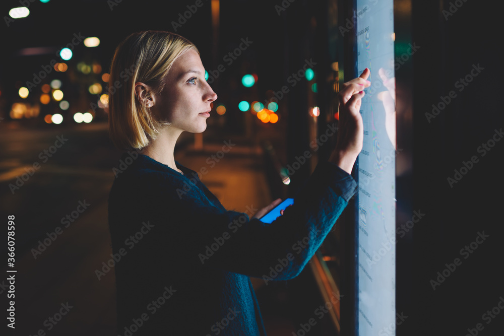 Gorgeous young woman touching big digital screen while consults about ...