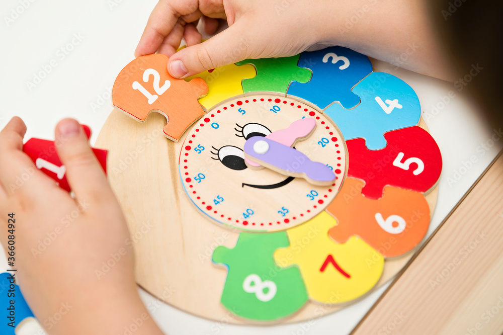 Boy learning time with wooden clock. Toy for Learning method for ...