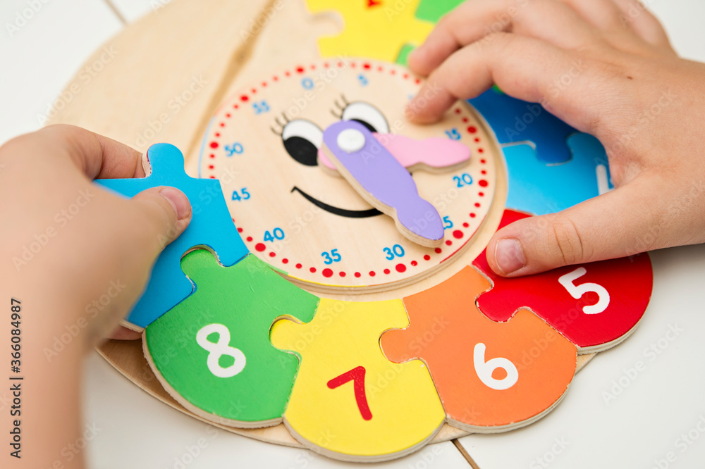Boy learning time with wooden clock. Toy for Learning method for ...