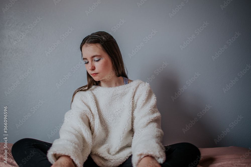 horizontal portrait of tween girl sitting and looking down Stock Photo ...