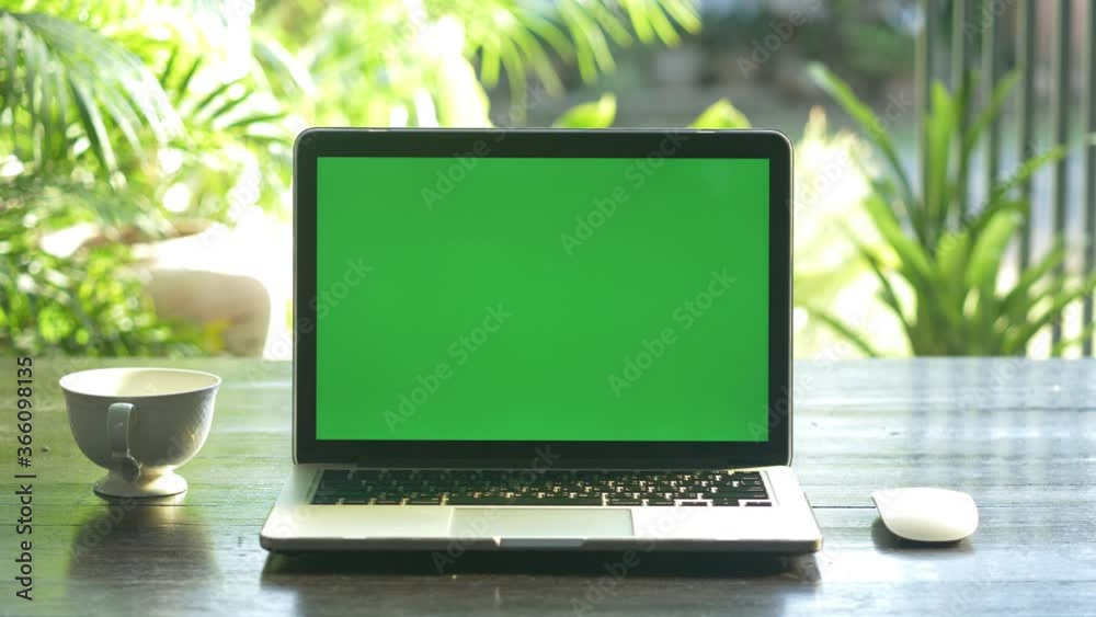 4K : A laptop computer with a key green screen set on work office table ...