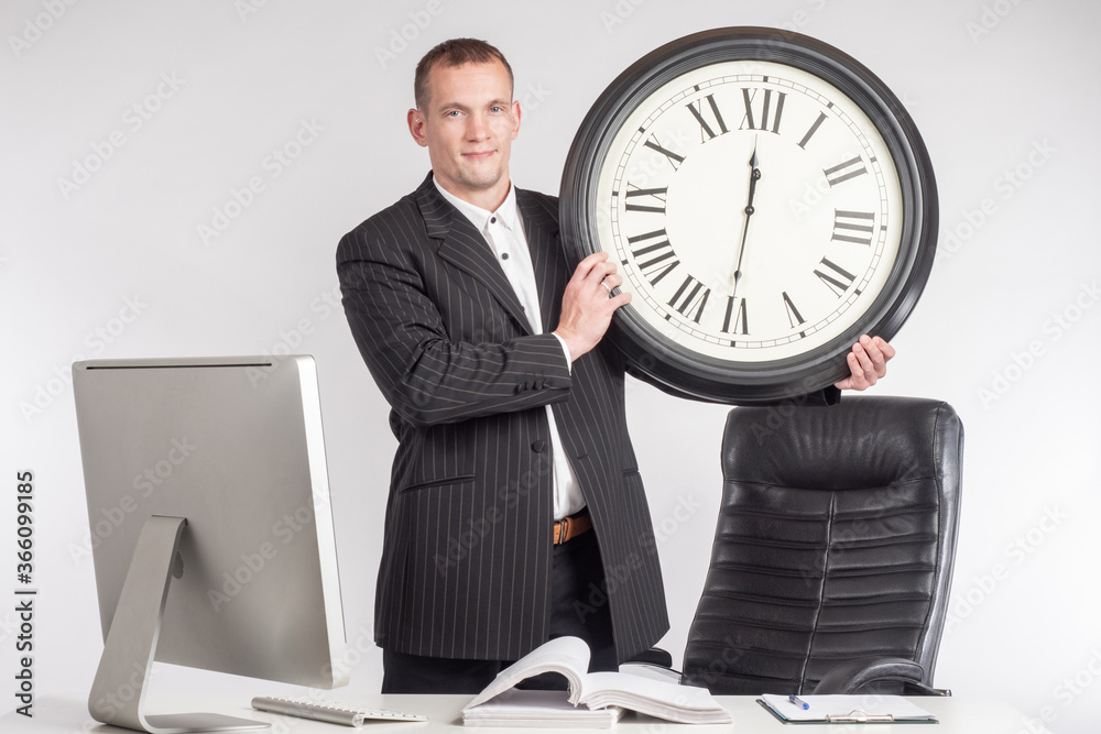 Businessman with a big clock in his hands. Business concept. Man holds ...