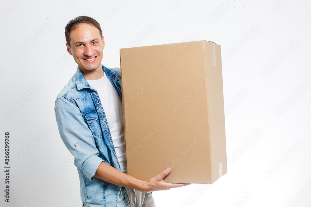 smiling delivery man holding a big parcel isolated on white Stock Photo ...