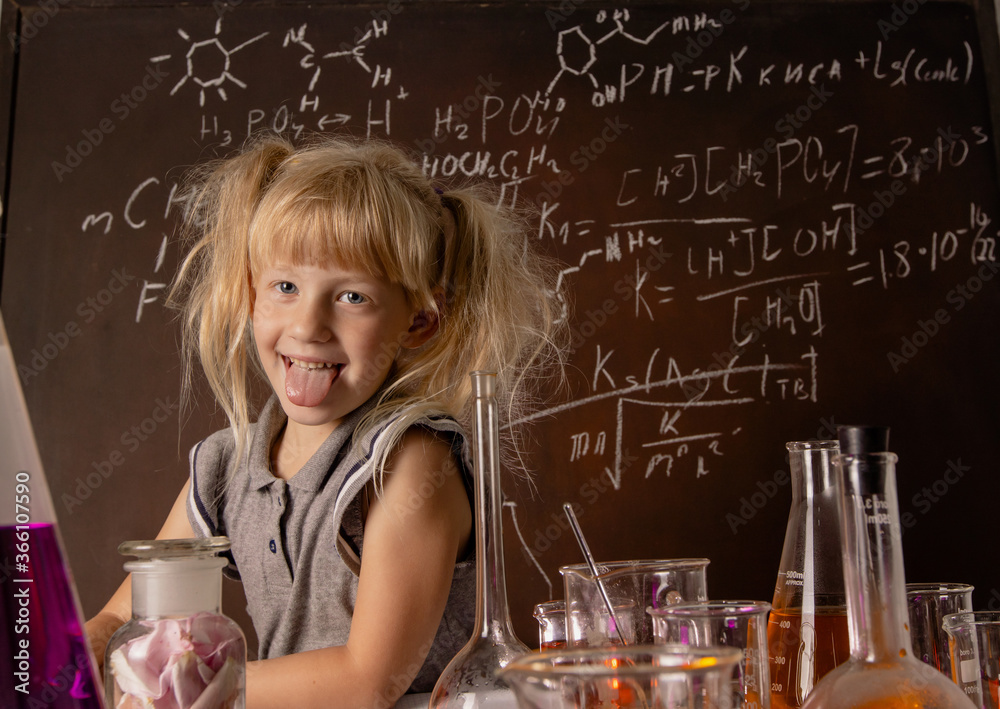 Curious little girl with test tubes and colorful substances making ...