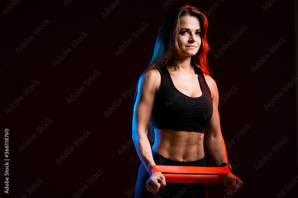 Portrait of a female boxer kickboxer who shakes her biceps and triceps ...