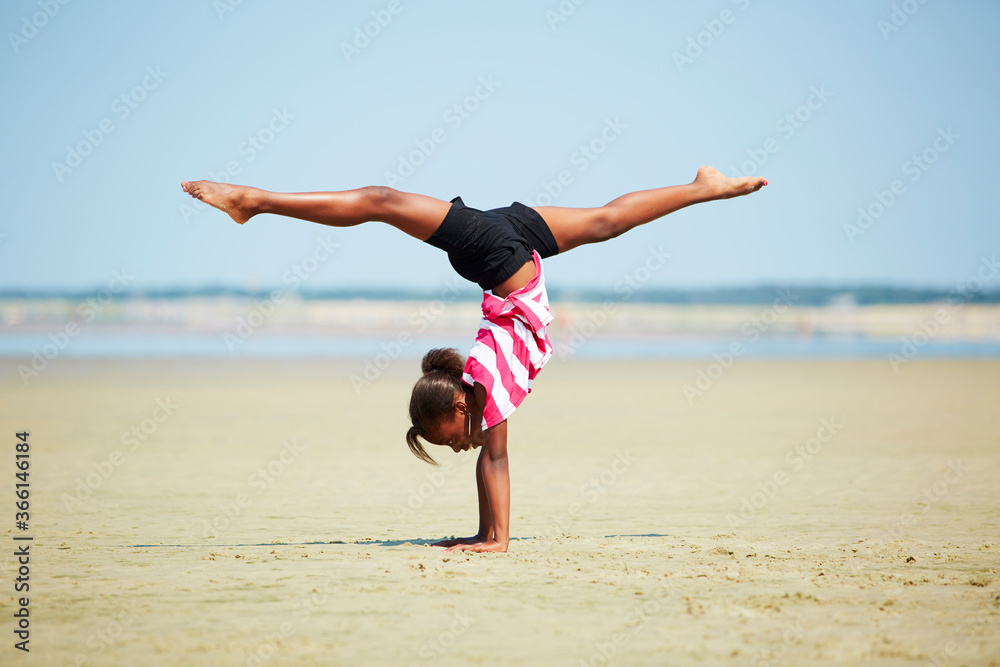 Girl Handstand On The Beach