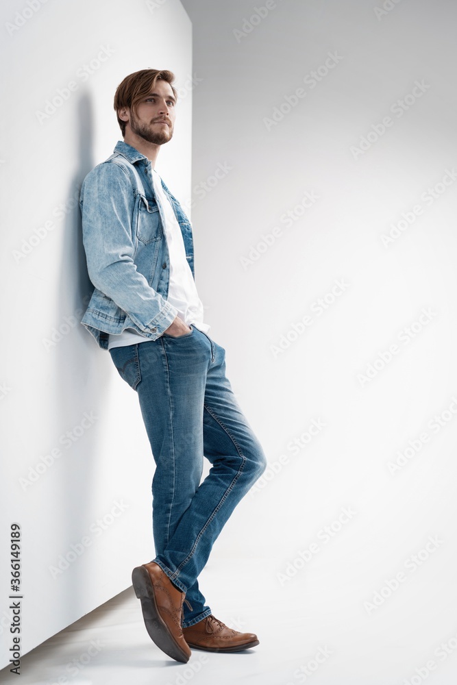 Fashion portrait of young man wearing jeans jacket Stock Photo | Adobe ...
