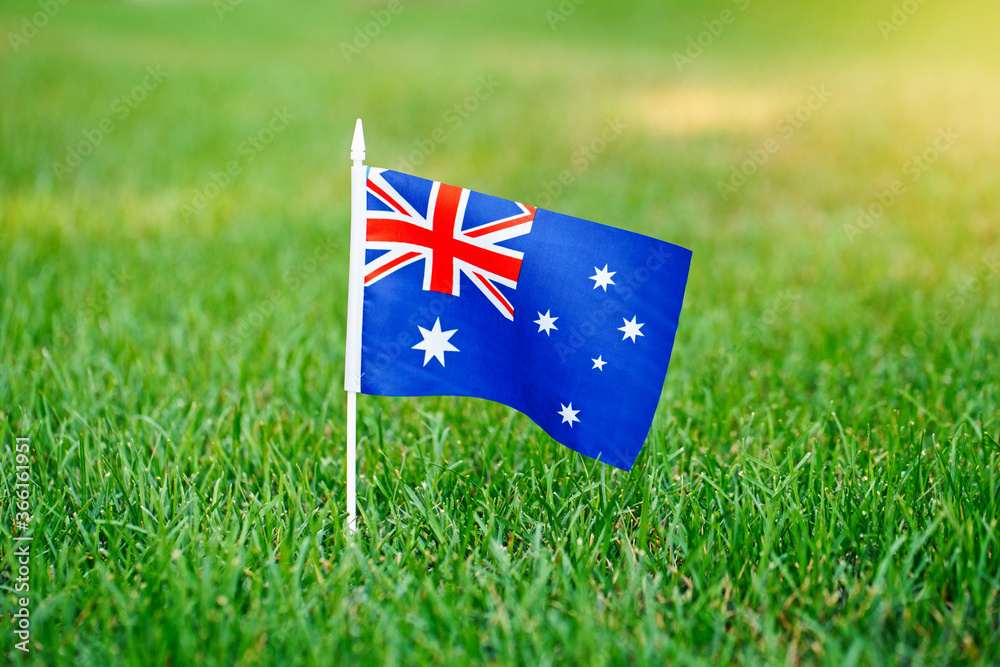 Australian flag standing on green grass. Australia day national holiday ...