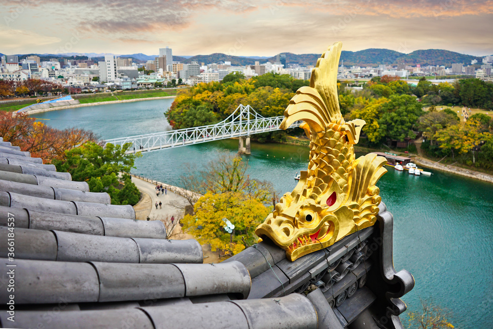 Gold Japanese fish statue on top of Okayama castle and river view in ...