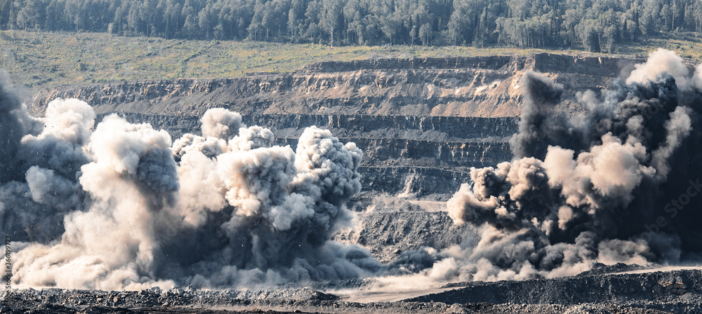 Explosive works on open pit coal mine industry with dust and puffs of ...