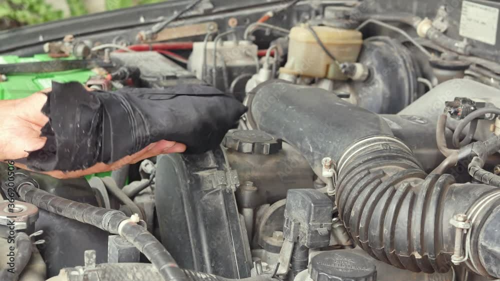 Cars mechanic is checking the level of engine oil from the engine oil ...
