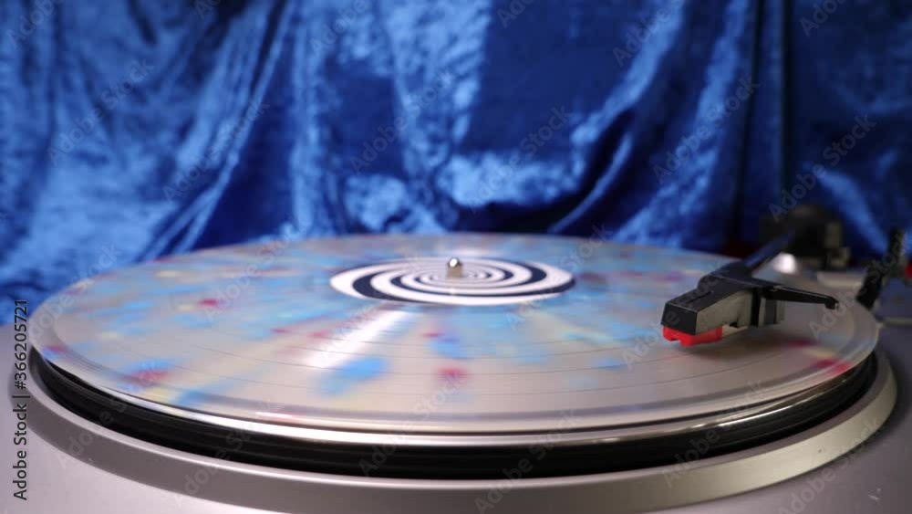 Stylus arm and needle lowered on 12” clear splatter vinyl record on DJ ...