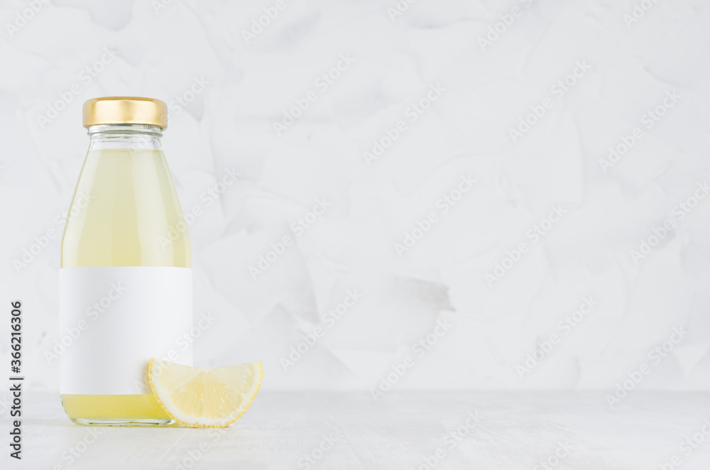 Organic yellow lemon juice in glass bottle mock up with blank label ...