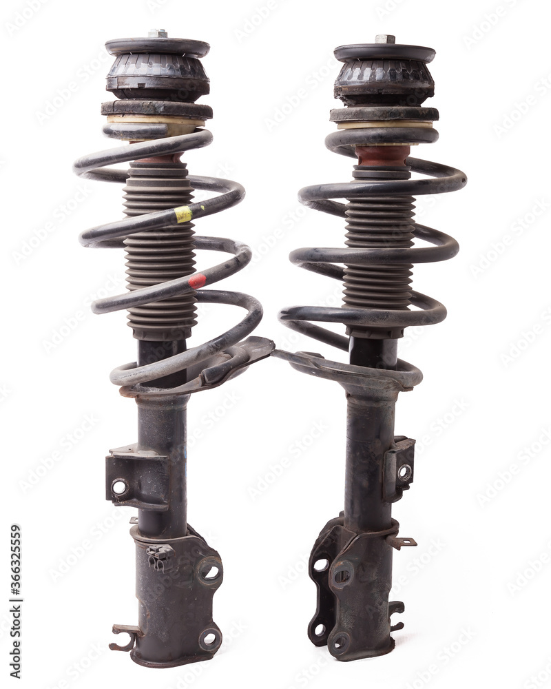 Two shock absorber struts with black springs after being used on a car ...