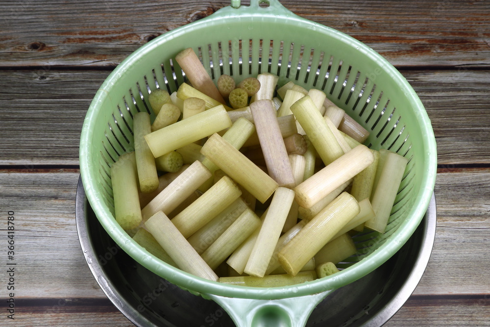 Pile of cutting fresh lotus stem (lotus root) in the plastic basket ...