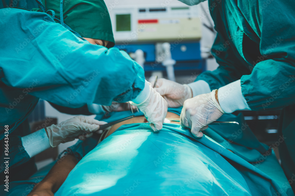 Medical team of surgeons in hospital doing invasive surgical ...