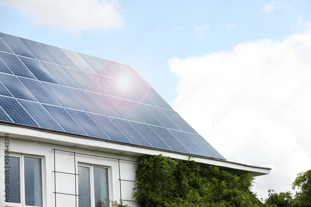 Building with installed solar panels on roof. Alternative energy source ...