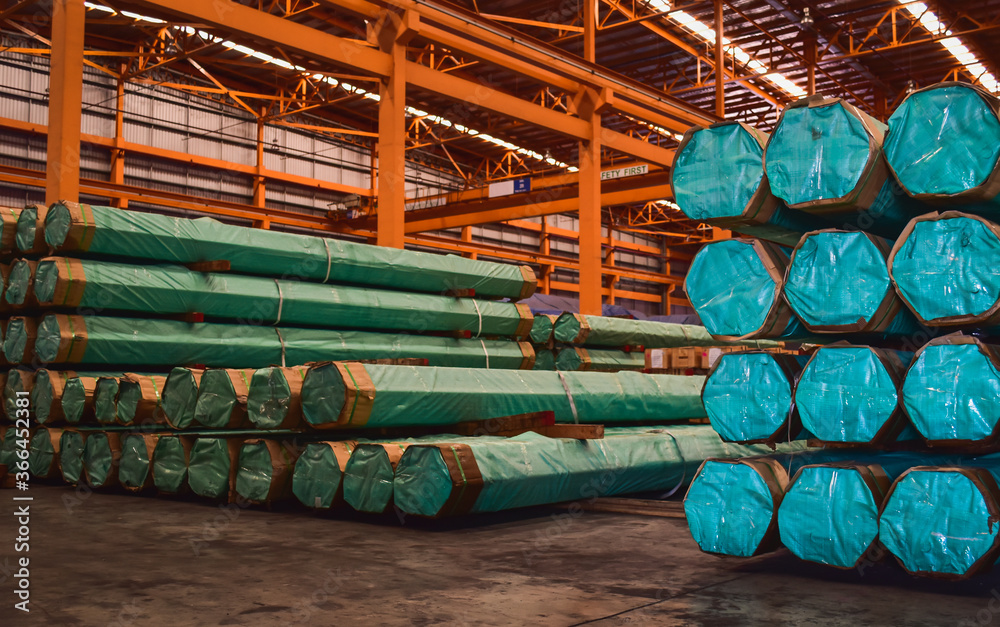Packs of steel tube stack in layers inside storage area of large ...