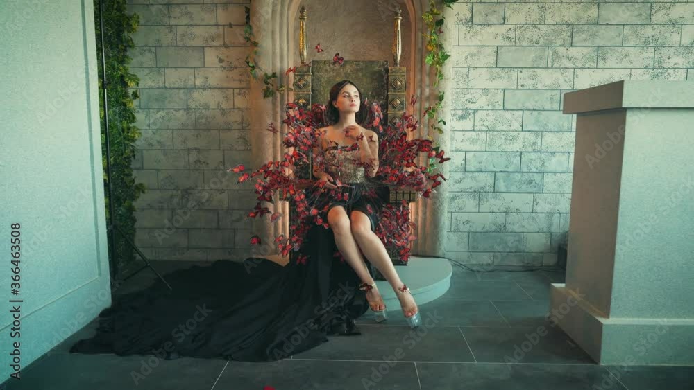 Vidéo Stock Beautiful fairy tale young woman princess sits on royal ...
