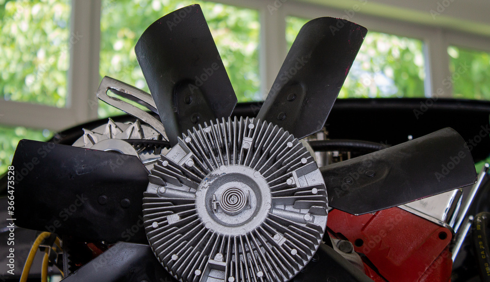 Fan wheel of a V8 engine built into a body shell of a muscle car. Taken ...