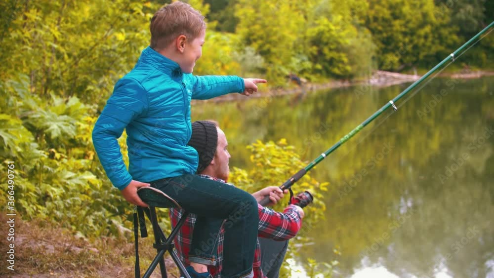 Vidéo Stock Two brothers on fishing - man holding the rod and his ...