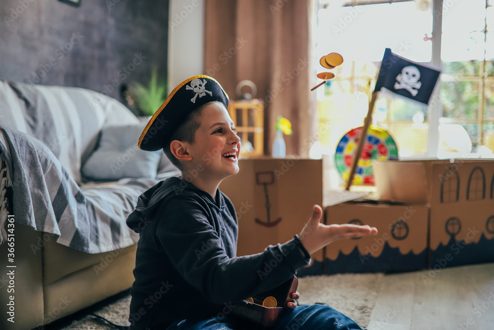 The little boy imagining the pirate excitedly throws and bites the gold ...