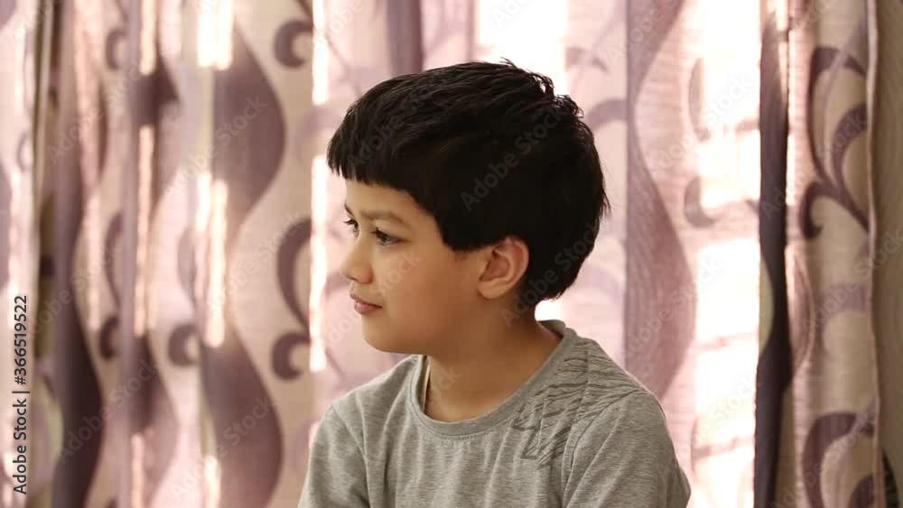 six year old Indian boy showing his grown up hair just before having a ...
