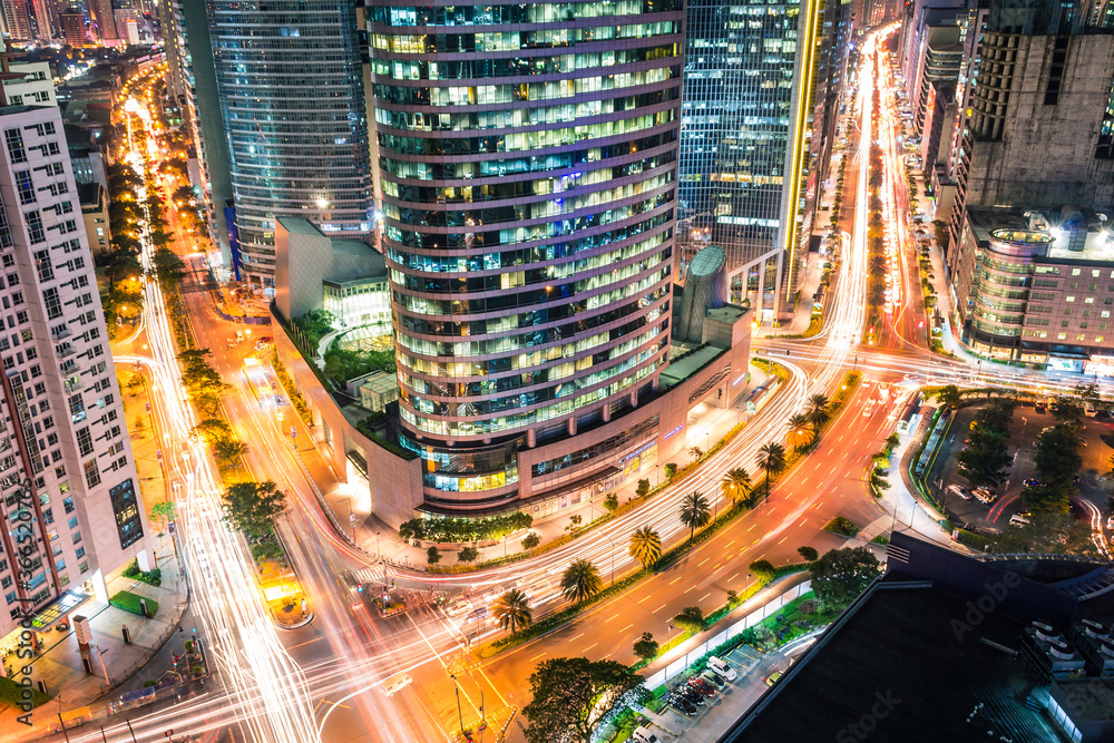 Intersection of Buendia and Ayala Avenue at night, during rush hour ...