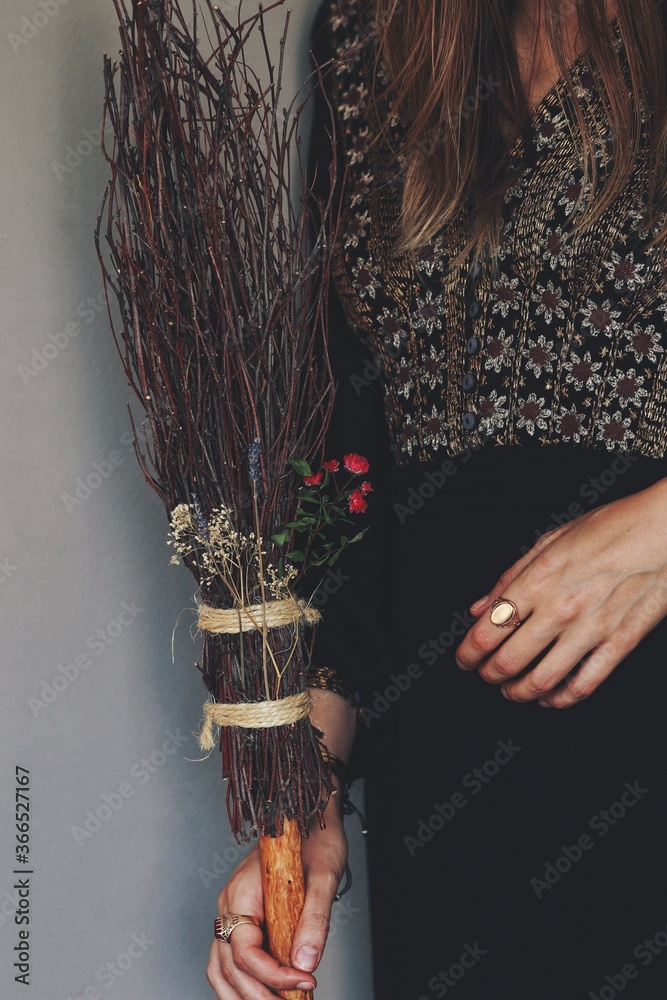 Female woman wiccan witch standing against dark textured blue purple ...