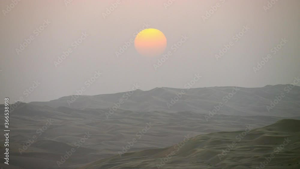 A rare picture-perfect sunset of the Arabian desert as it zooms out of ...
